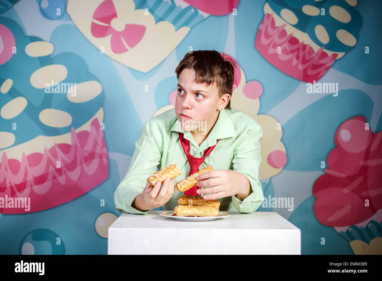 Funny teenage boy eating sweet cakes, hungry and candy man Stock Photo ...