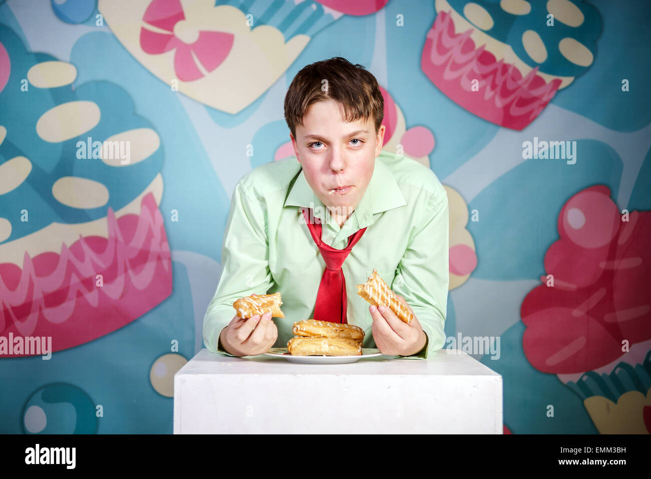 Funny teenage boy eating sweet cakes, hungry and candy man Stock Photo ...