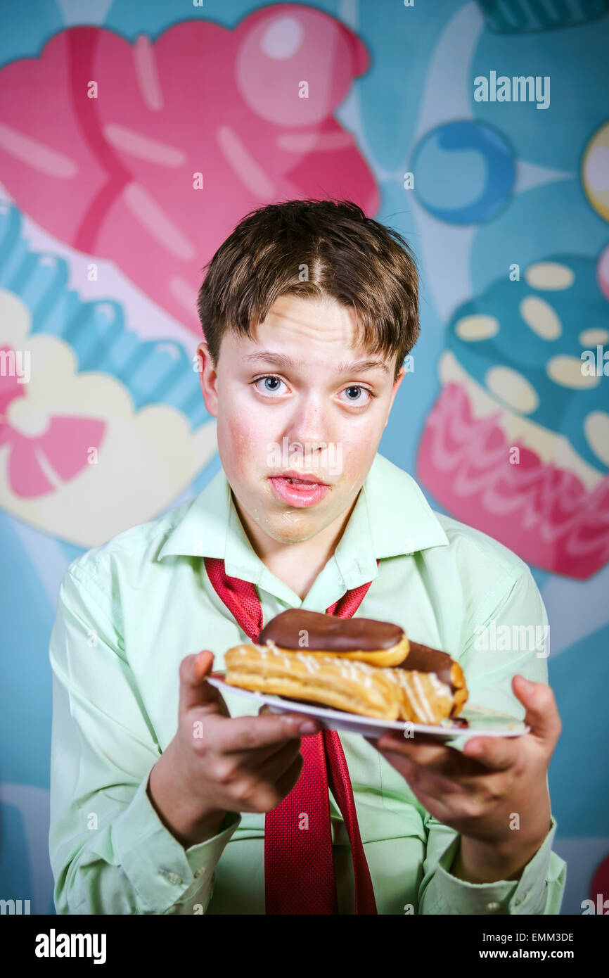 Funny teenage boy eating sweet cakes, hungry and candy man Stock Photo ...