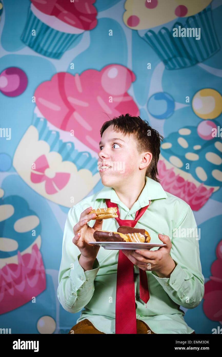 Funny teenage boy eating sweet cakes, hungry and candy man Stock Photo ...