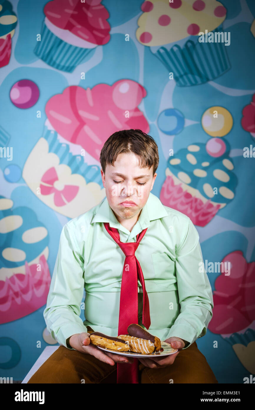 Funny teenage boy eating sweet cakes, hungry and candy man Stock Photo ...