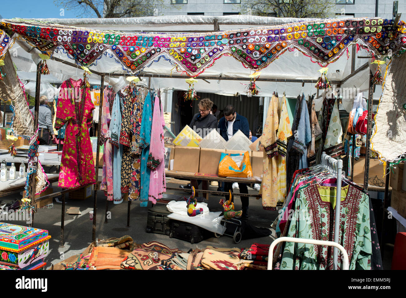 Netil market, a stall with carpets, clothes and painted craft from ...
