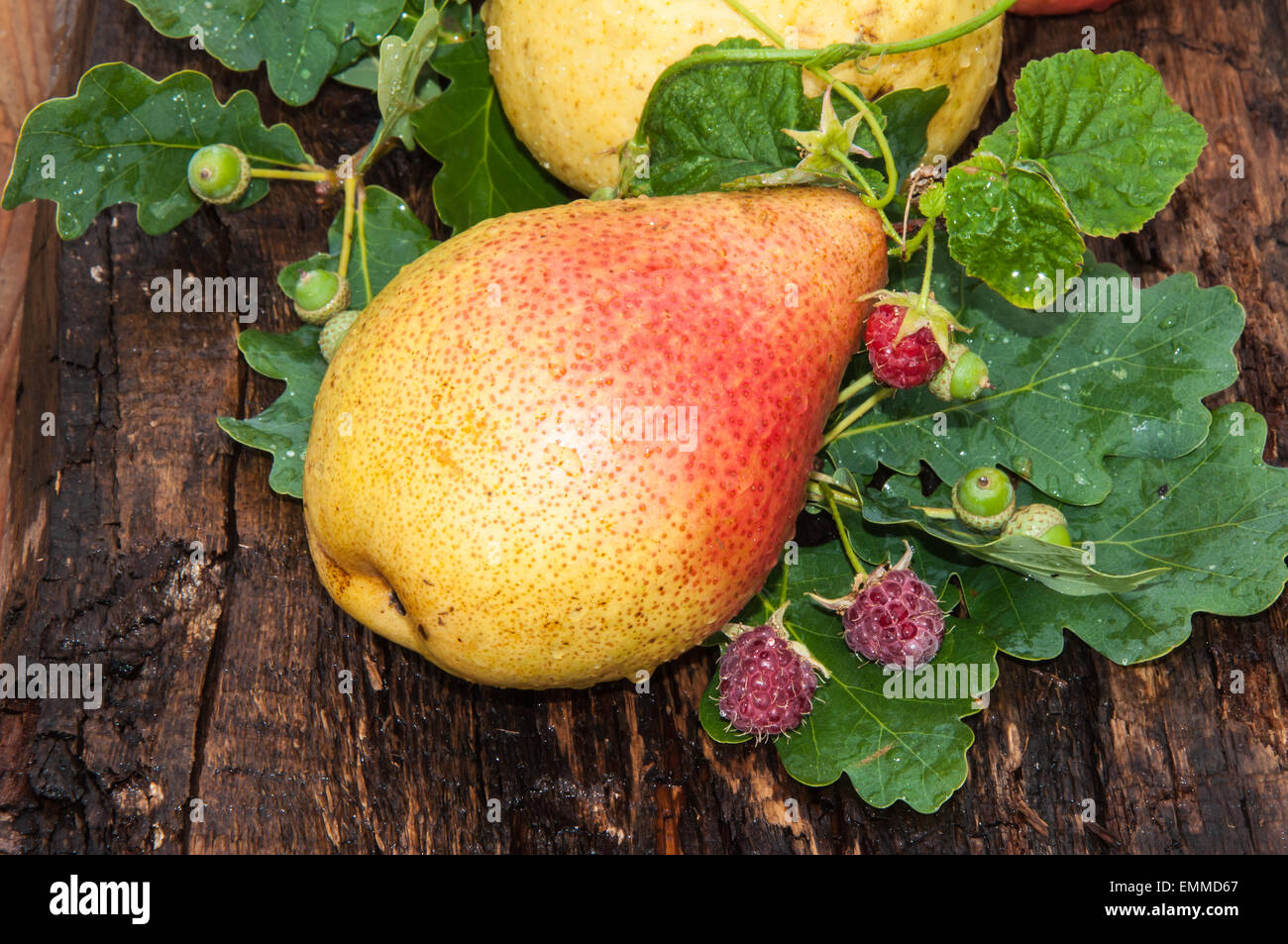 Ripe pear and berry raspberry on wood countertop Stock Photo - Alamy