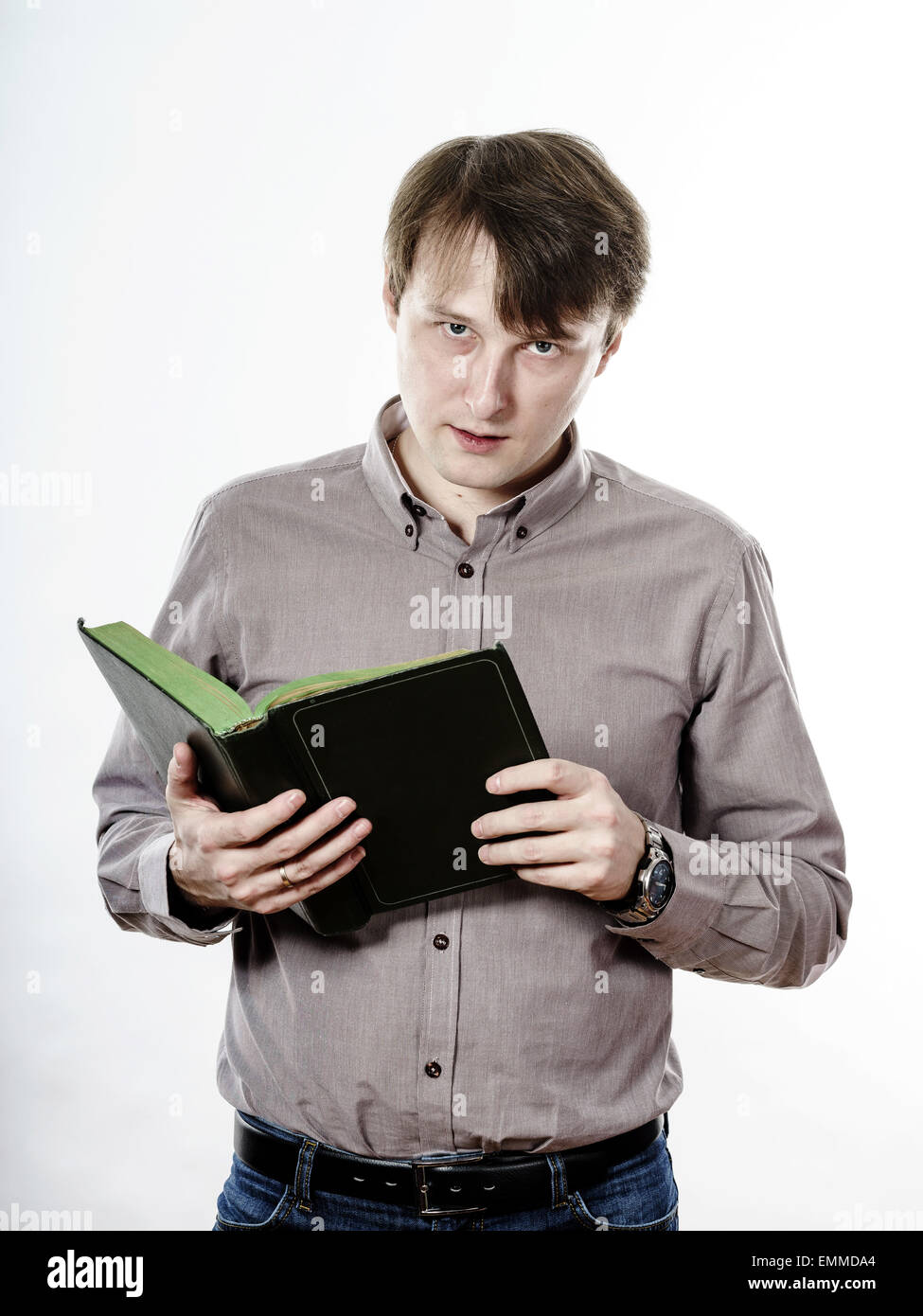 Young caucasian man reading book, portrait isolated on white background ...