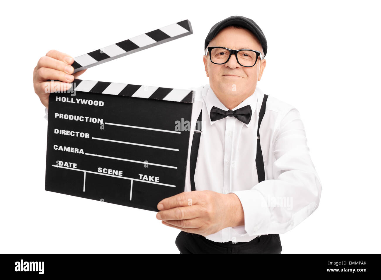 Senior movie director holding a movie clapper, smiling and looking at ...