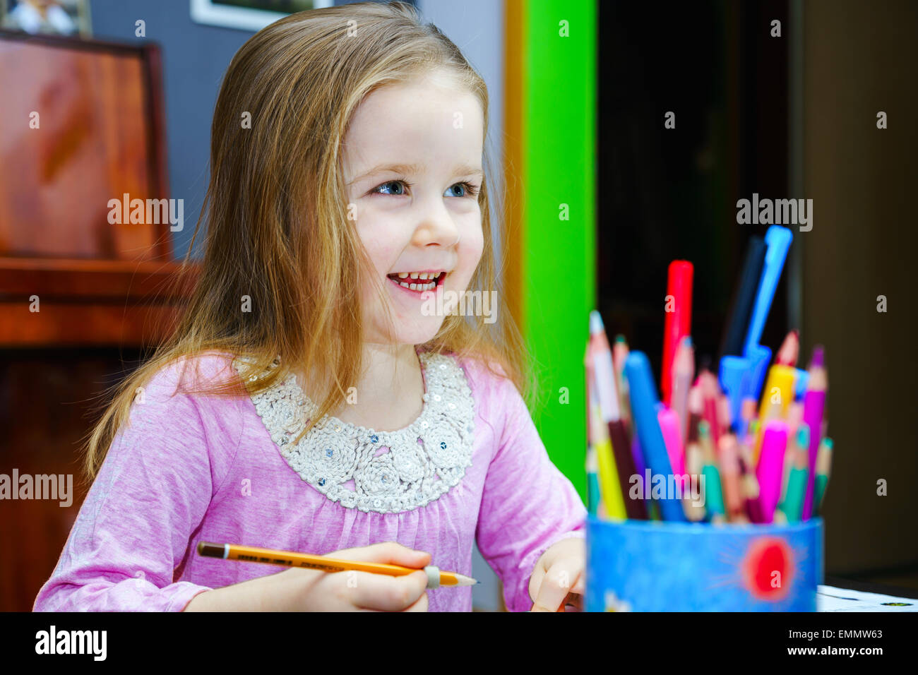 Cute little girl studing to speaking and writing letters at home lesson ...