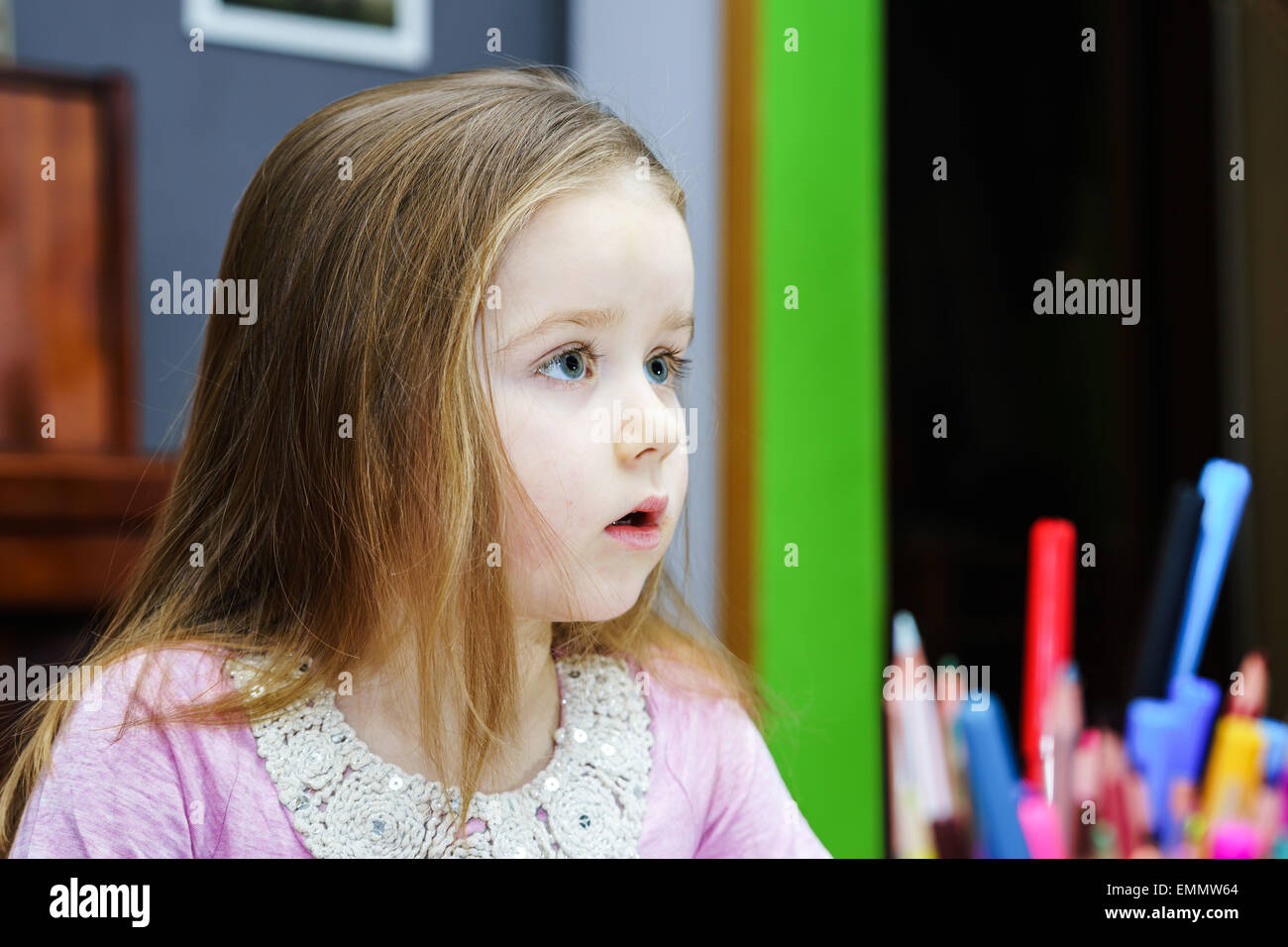 Cute little girl studing to speaking and writing letters at home lesson ...
