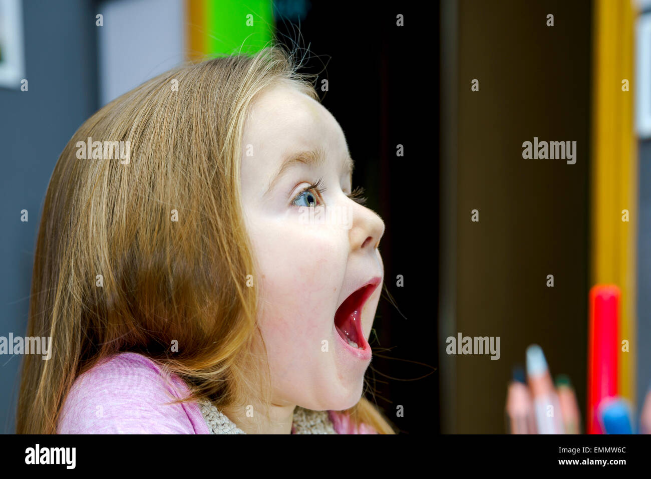 Cute little girl studing to speaking and writing letters at home lesson ...