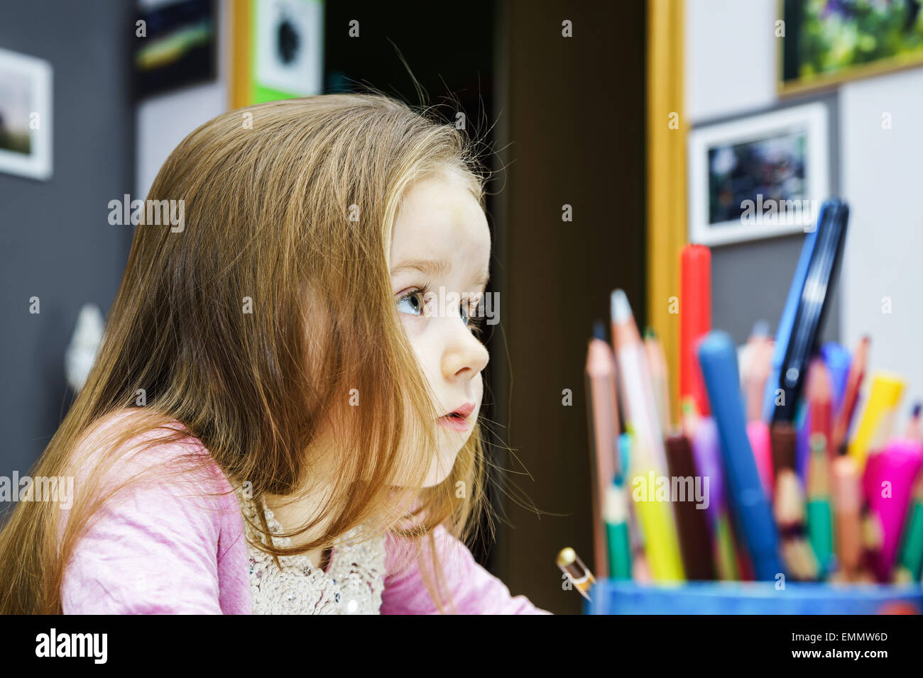 Cute little girl studing to speaking and writing letters at home lesson ...