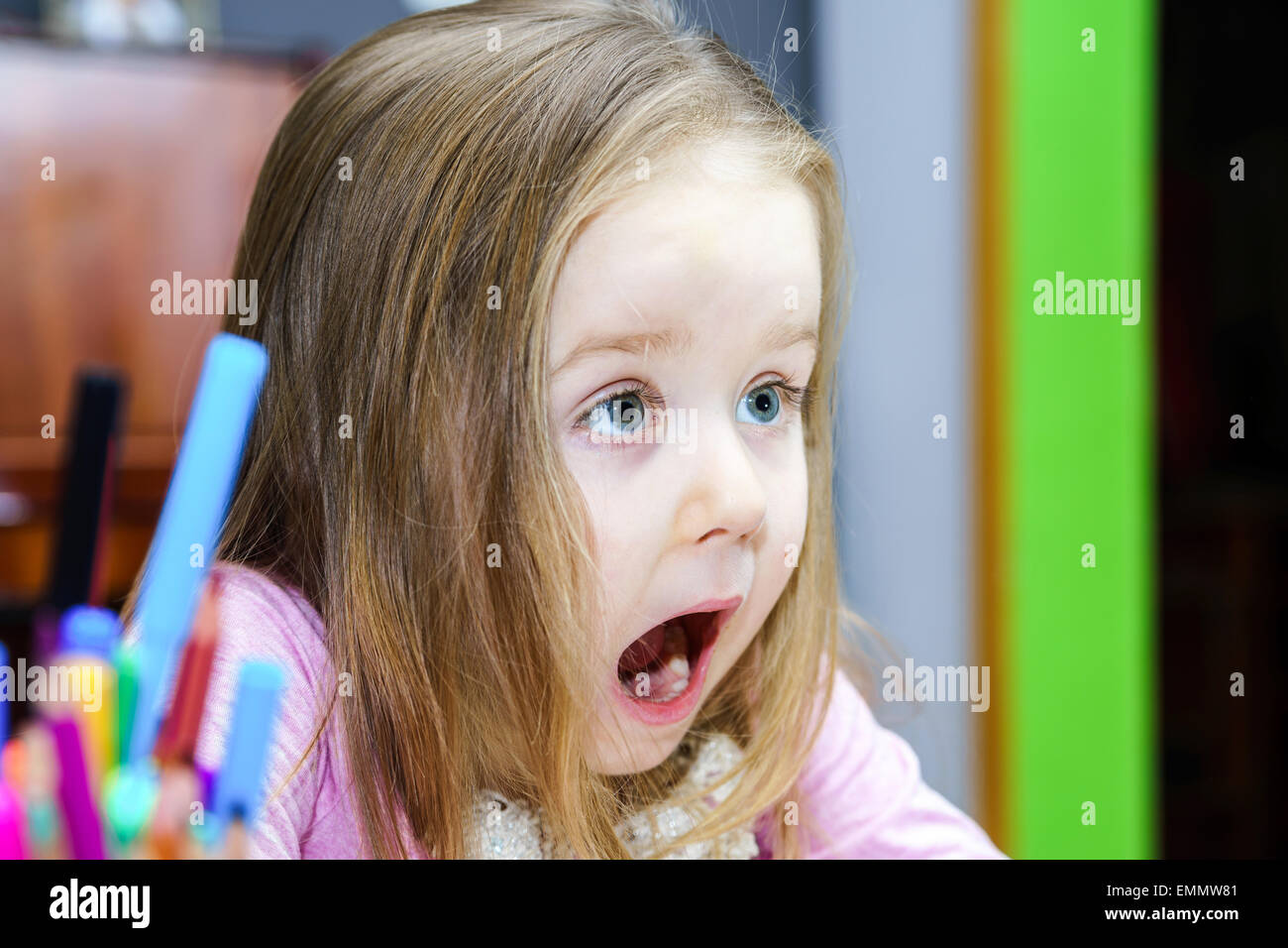 Cute little girl studing to speaking and writing letters at home lesson ...
