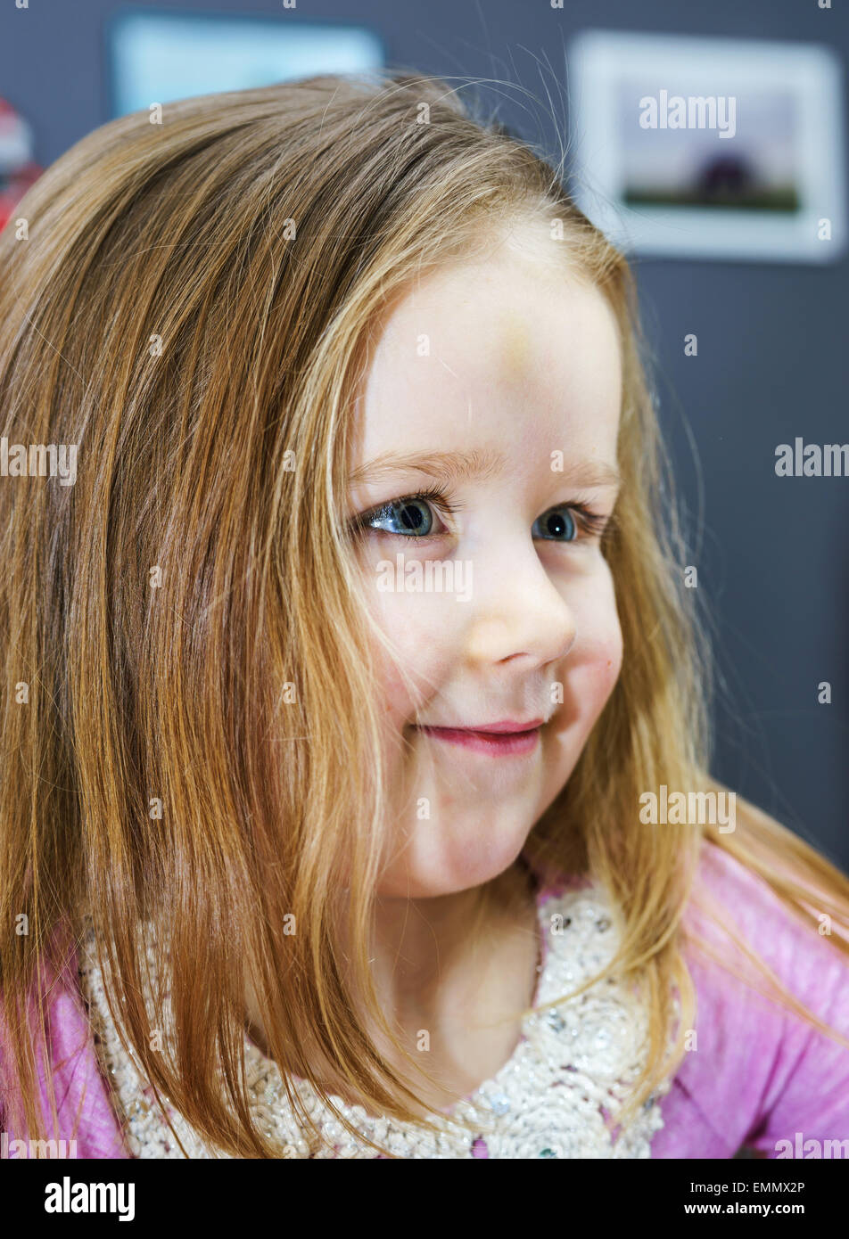 Cute little girl studing to speaking and writing letters at home lesson ...