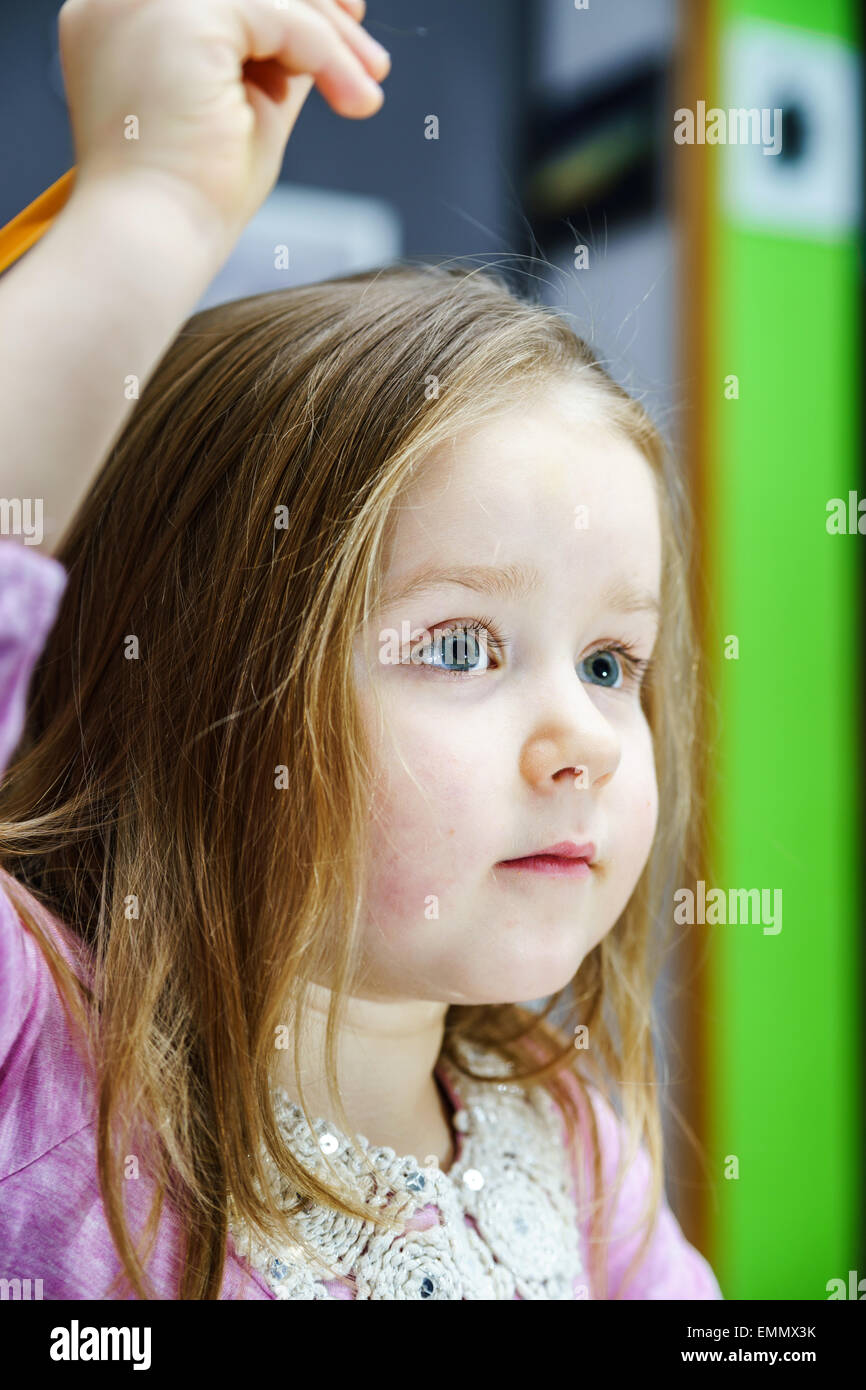 Cute little girl studing to speaking and writing letters at home lesson ...