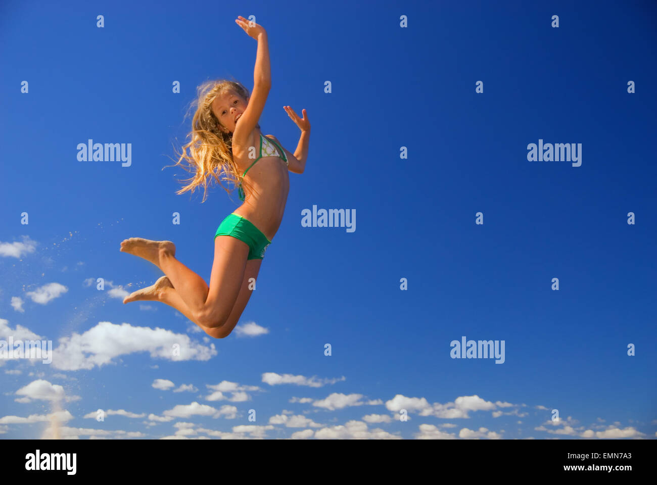 Little girl jumps in the sky Stock Photo - Alamy