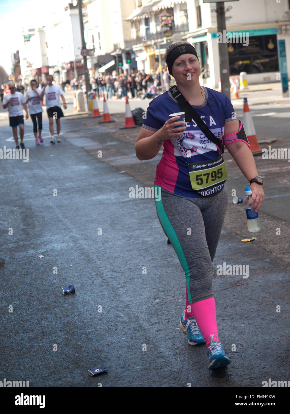 Exhausted marathon runners slowly make their way to the finishing line ...