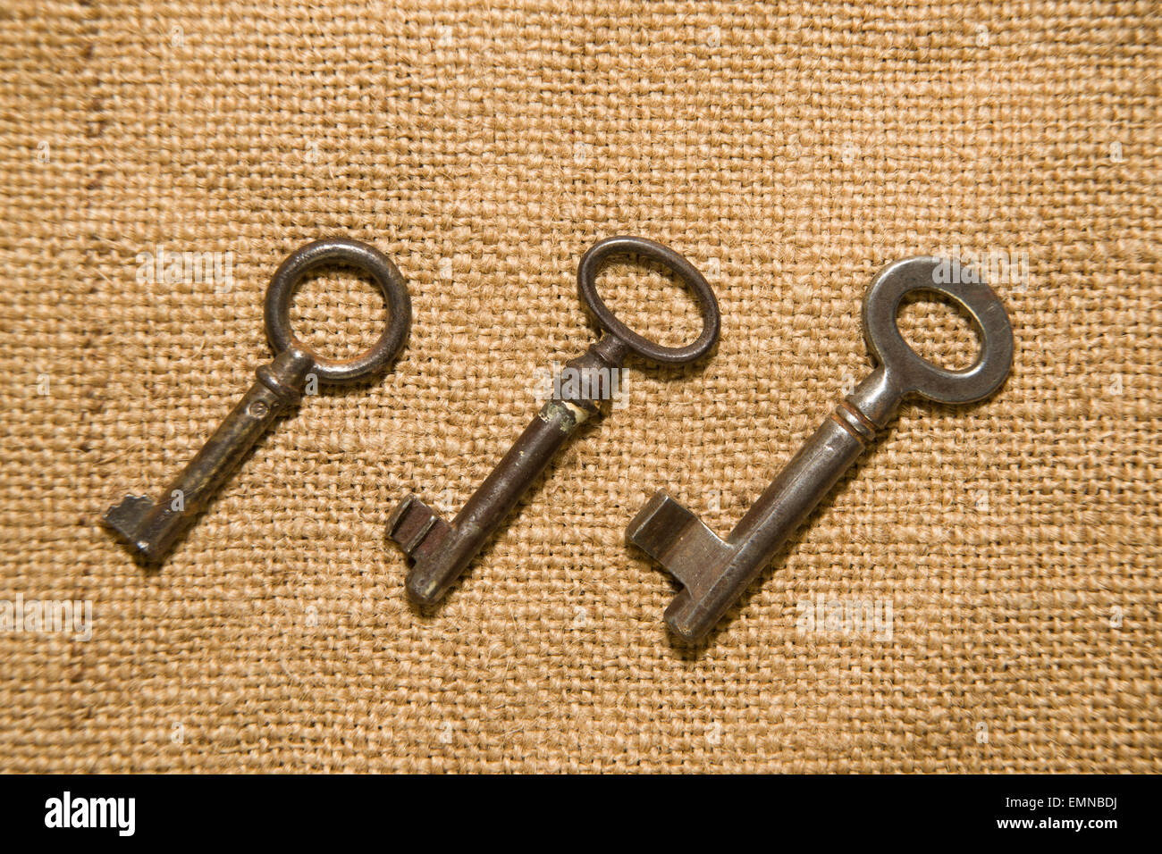 Three vintage keys to the safe on old cloth Stock Photo - Alamy