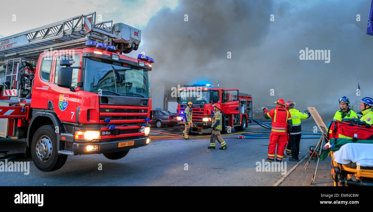 Firemen at the scene of a fire involving a small business. Kopavogur ...