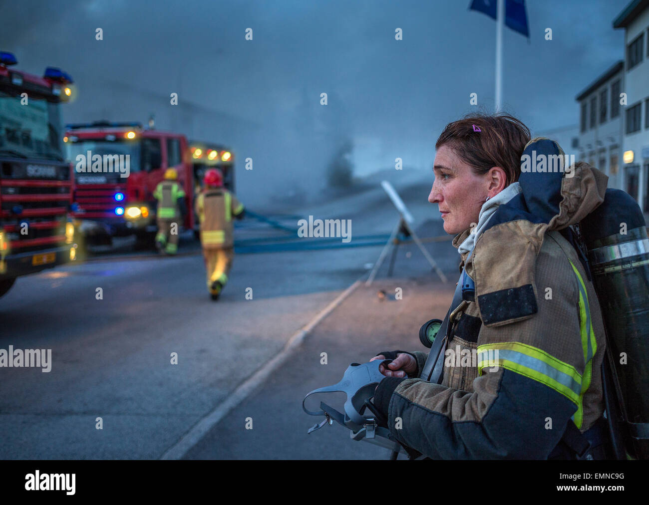 Firemen at the scene of a fire involving a small business. Kopavogur ...