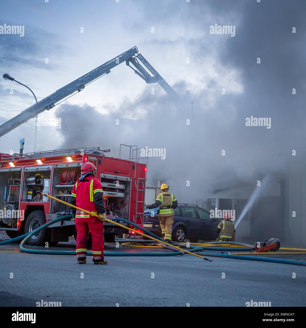 Firemen at the scene of a fire involving a small business. Kopavogur ...