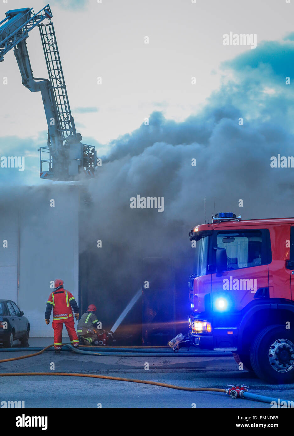 Firemen at the scene of a fire involving a small business. Kopavogur ...