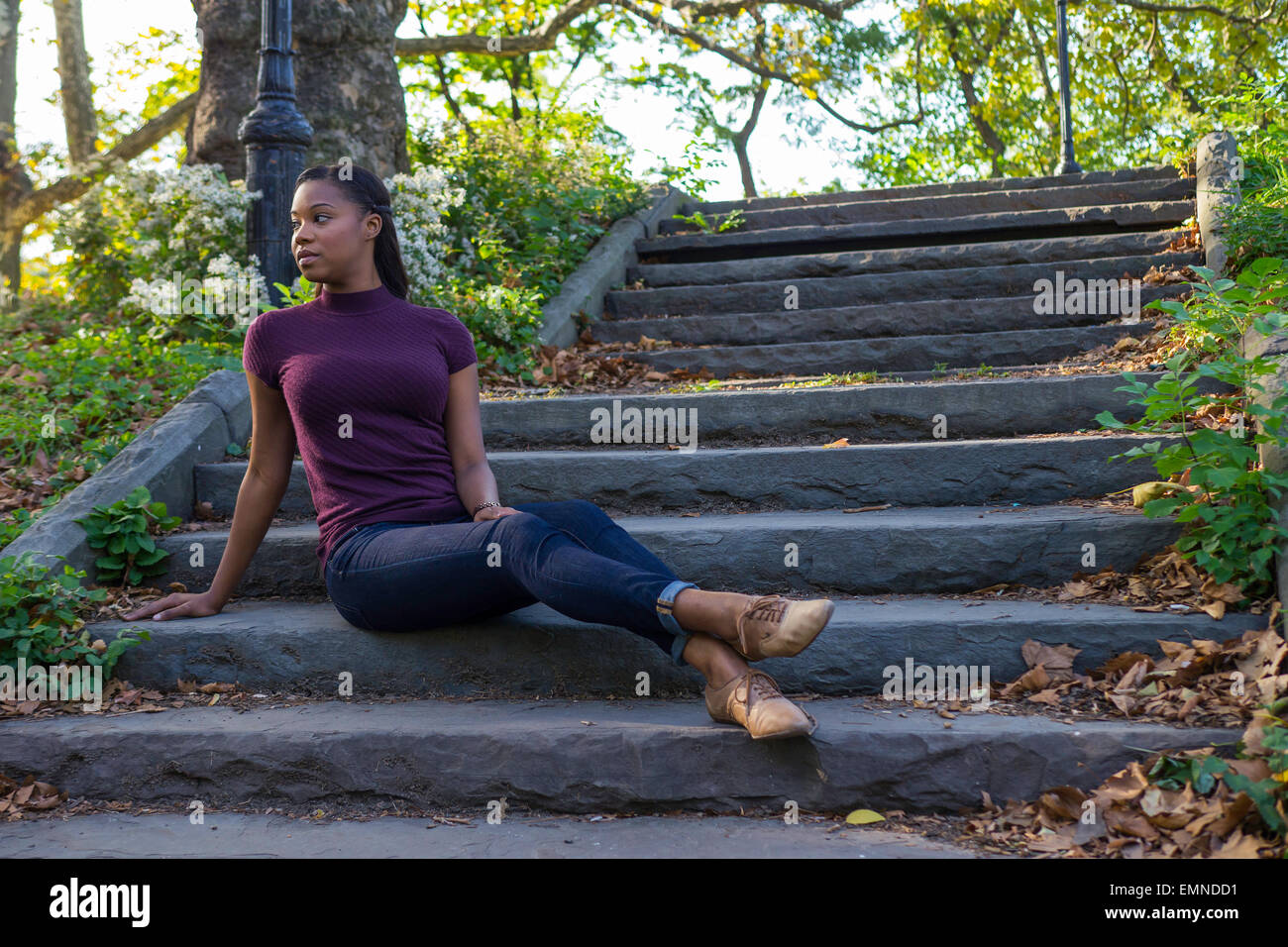 Woman sitting on stone hi-res stock photography and images - Alamy