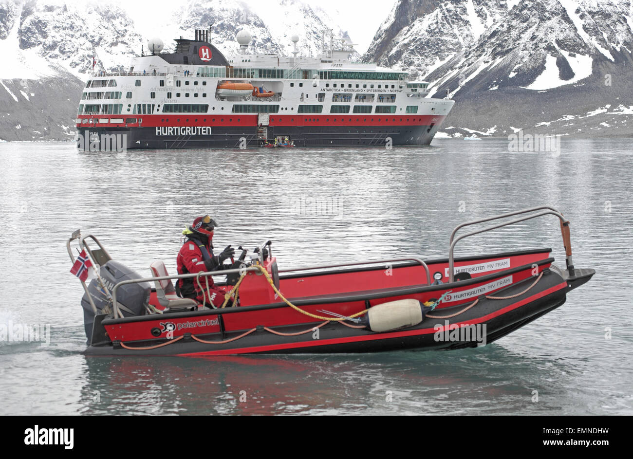 Zodiac boat with Hurtigruten's arctic cruise ship MV Fram, moored in ...