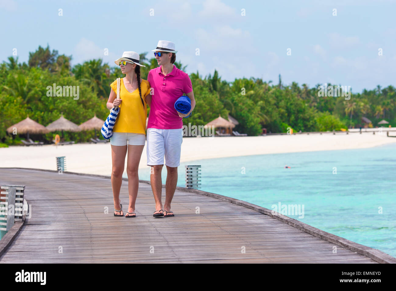 Couple on tropical beach jetty going to the beach at Maldives Stock ...
