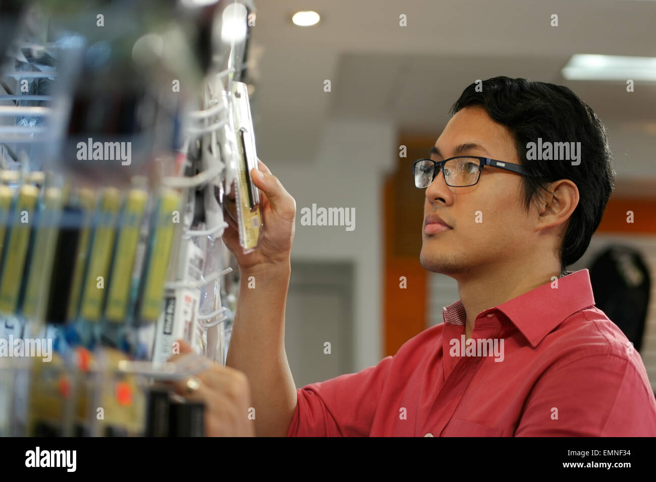Chinese sales clerk working in computer store, arranging and ordering ...
