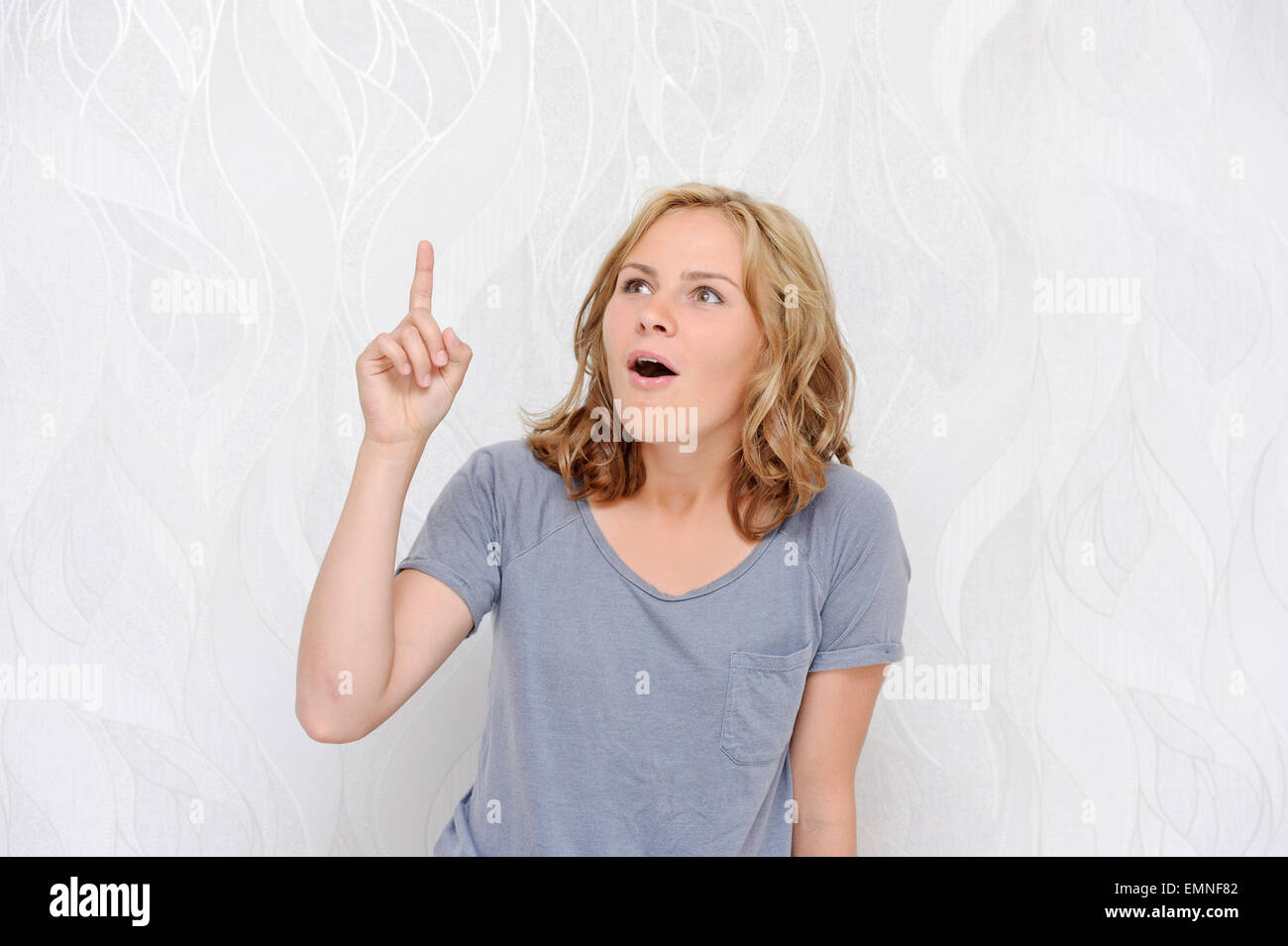 Young woman getting an idea Stock Photo - Alamy