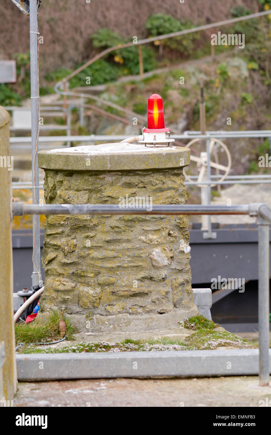Red warning light on harbour wall to warn boat skippers of boat ...