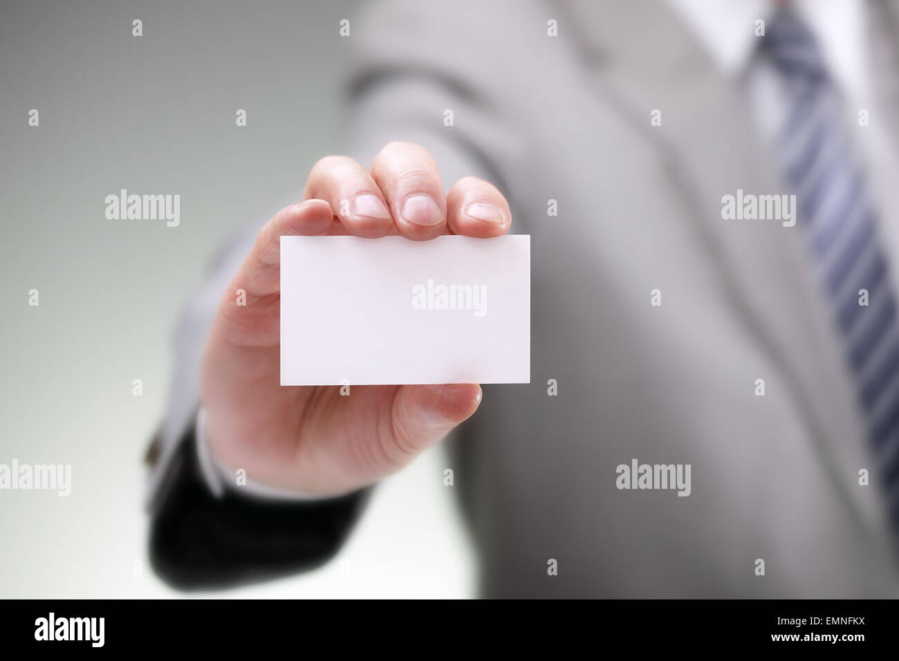 Businessman showing his business card Stock Photo - Alamy