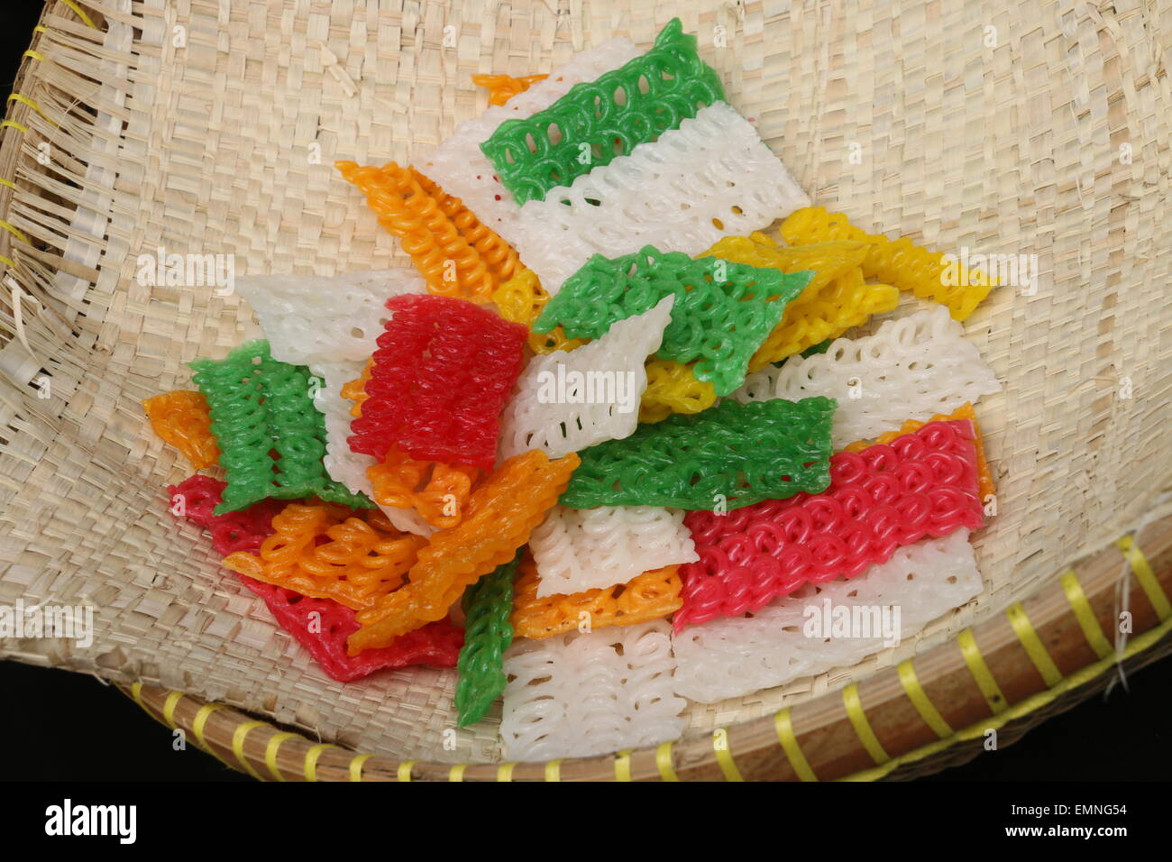 A handful of colorful curly crackers (Kasandra cracker) made from ...