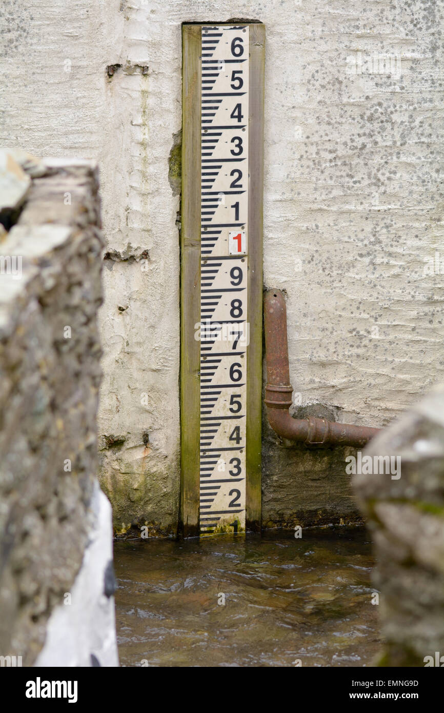Water depth marker in stream in Polperro, Cornwall, England Stock Photo ...