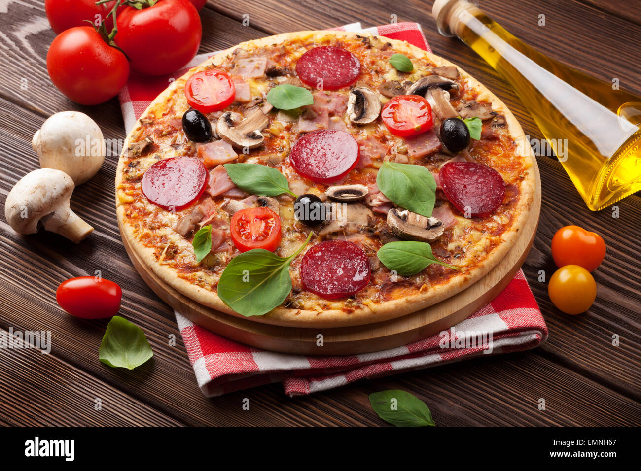Italian pizza with pepperoni on wooden table Stock Photo - Alamy