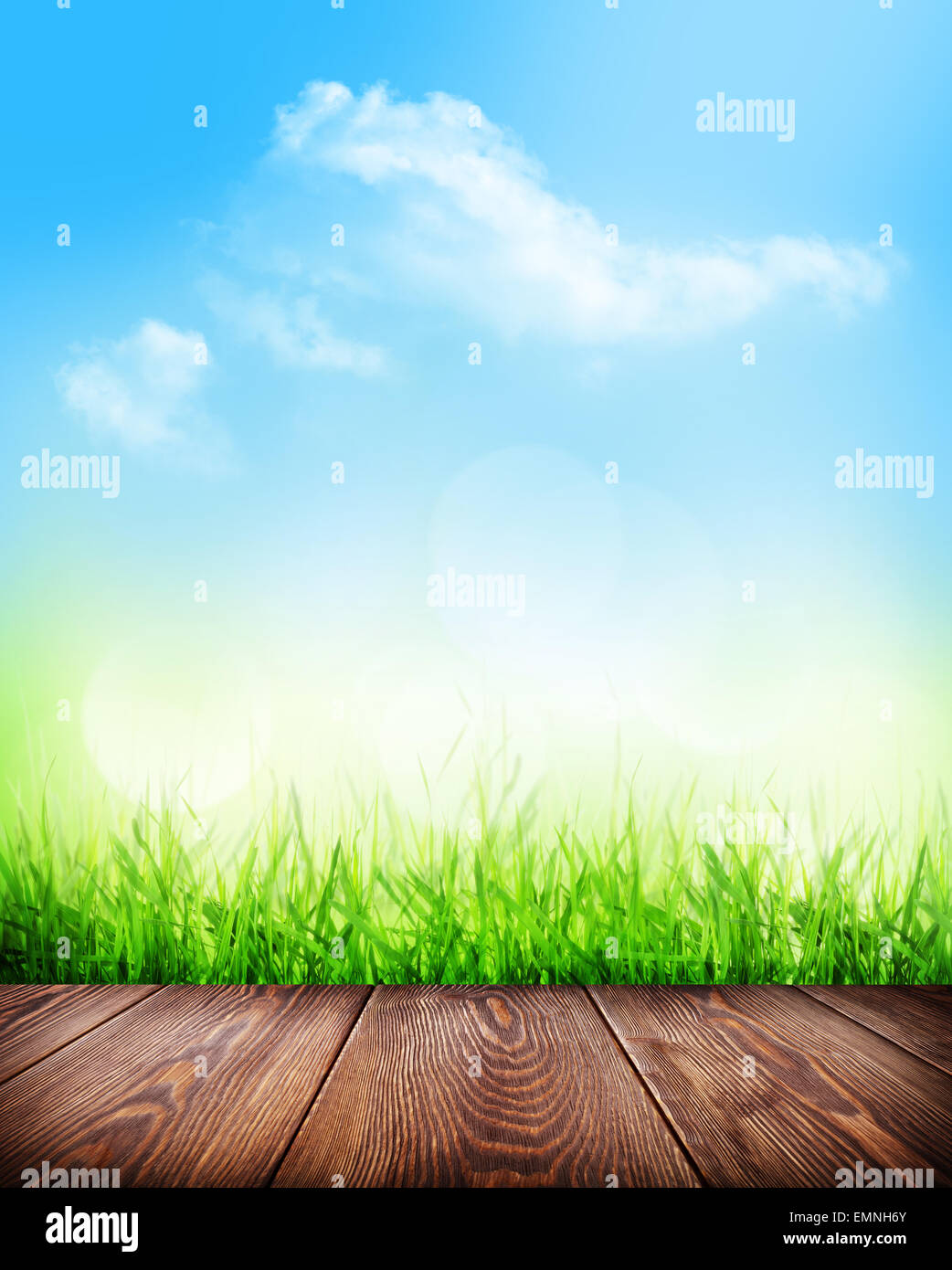Summer background with wooden floor, green grass and sunlight bokeh ...