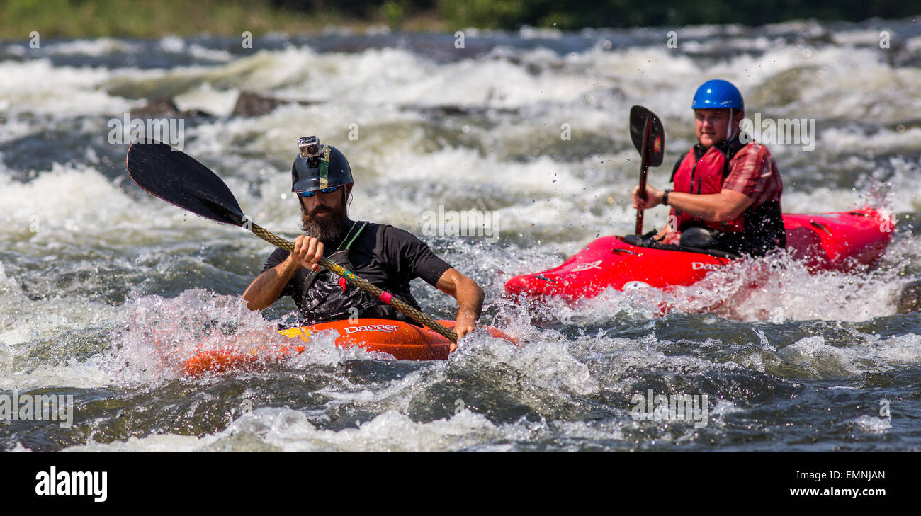 Kayakers make their way through the rapids in their kayaks Stock Photo ...