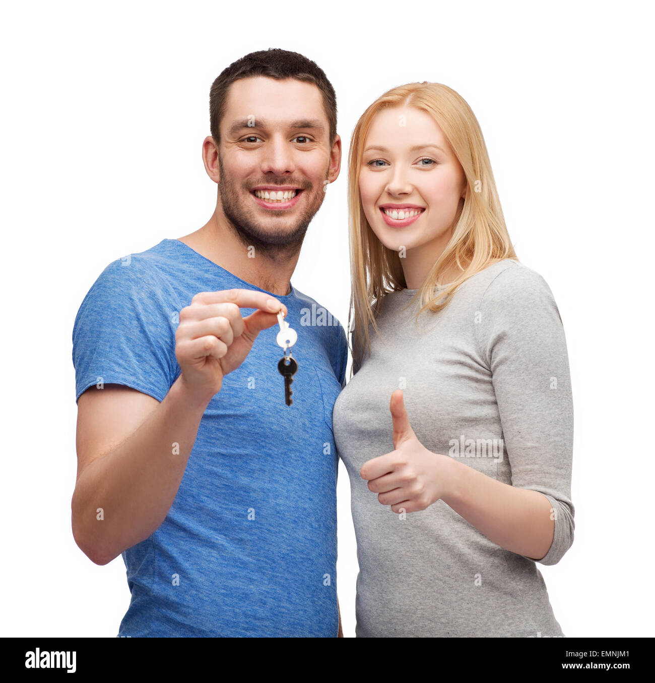 smiling couple holding keys and showing thumbs up Stock Photo - Alamy