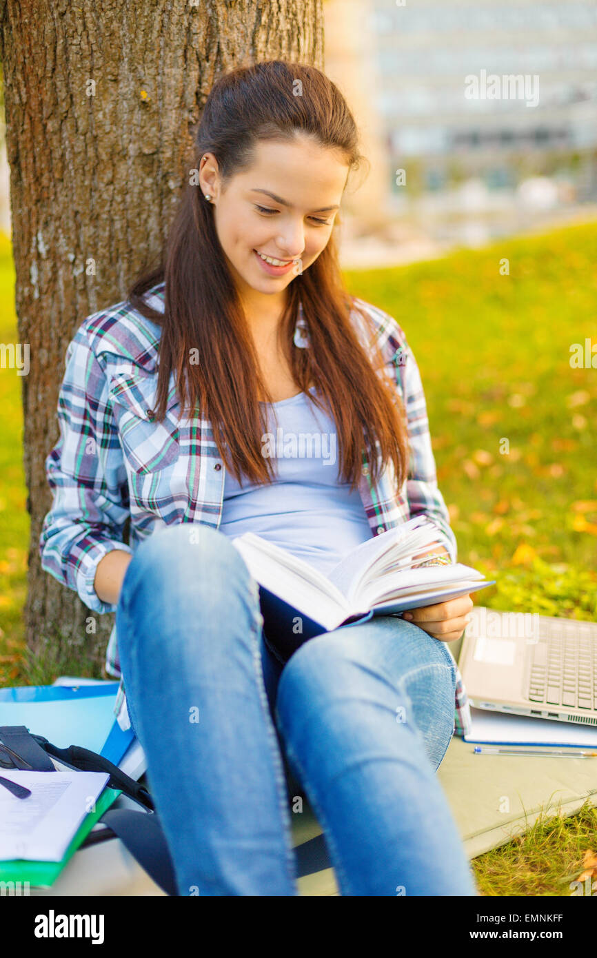 smiling teenager reading book Stock Photo - Alamy