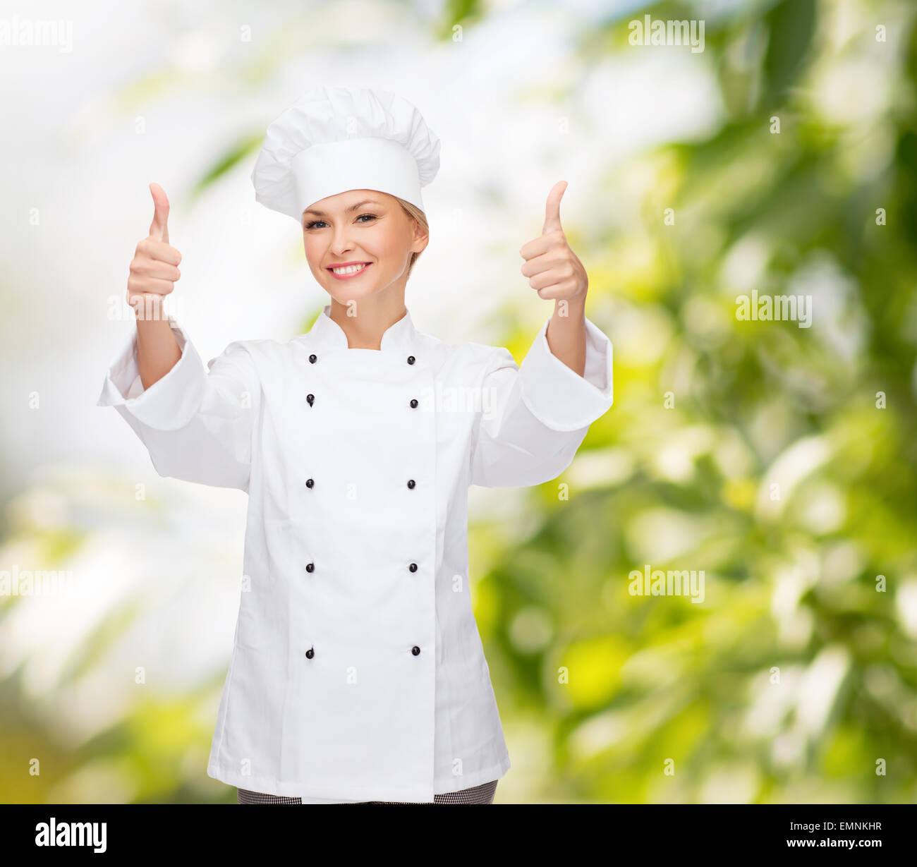 smiling female chef showing thumbs up Stock Photo - Alamy