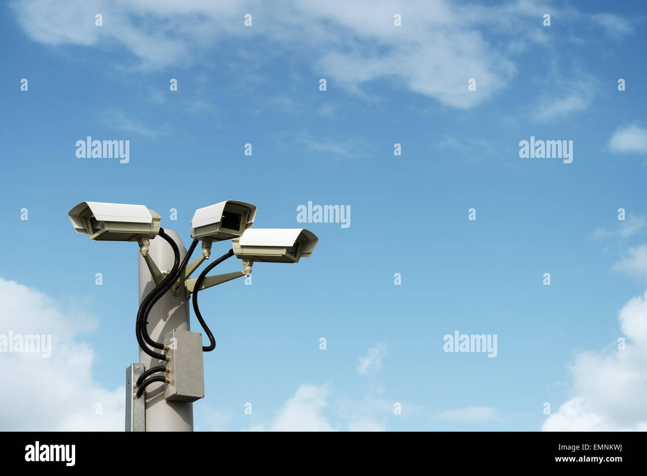 Security cctv surveillance camera in front of blue sky with copy space ...
