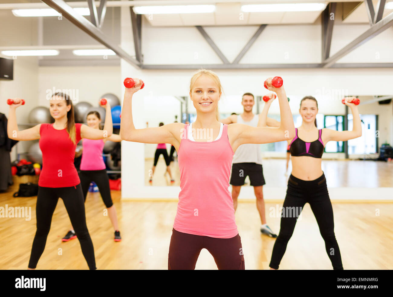 group of smiling people working out with dumbbells Stock Photo - Alamy