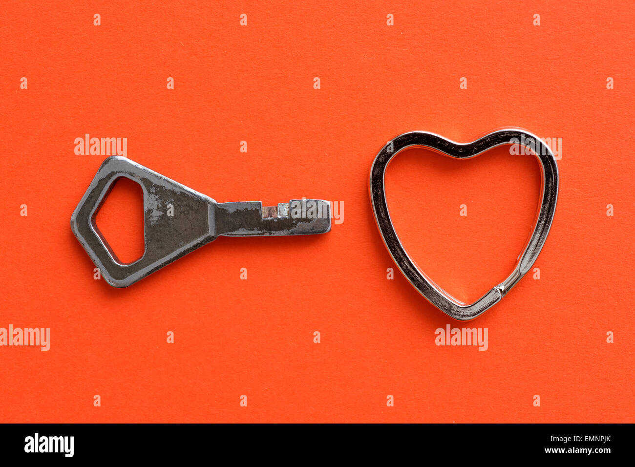 key and keyring in shape of heart on the red background Stock Photo - Alamy