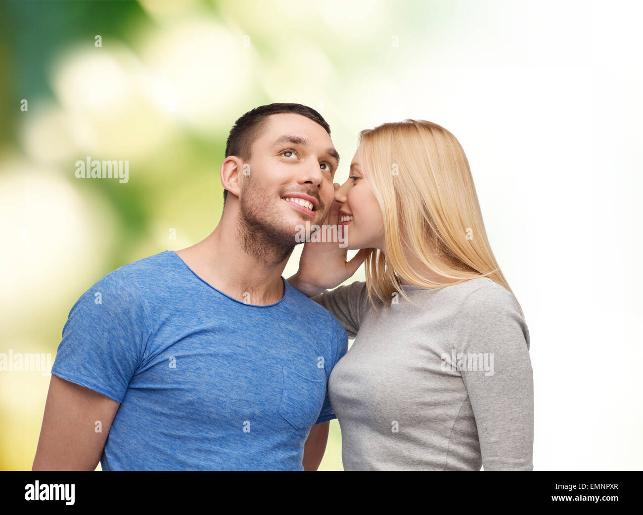 smiling girlfriend telling boyfriend secret Stock Photo - Alamy