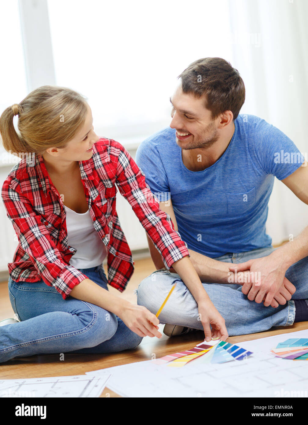 smiling couple looking at color samples at home Stock Photo - Alamy
