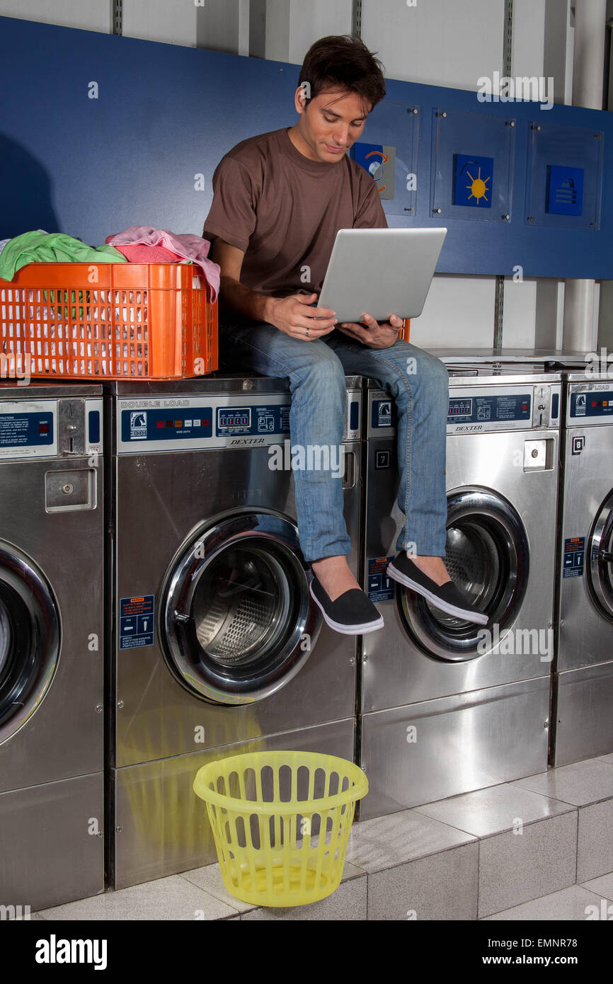 Man in the laundry Stock Photo - Alamy