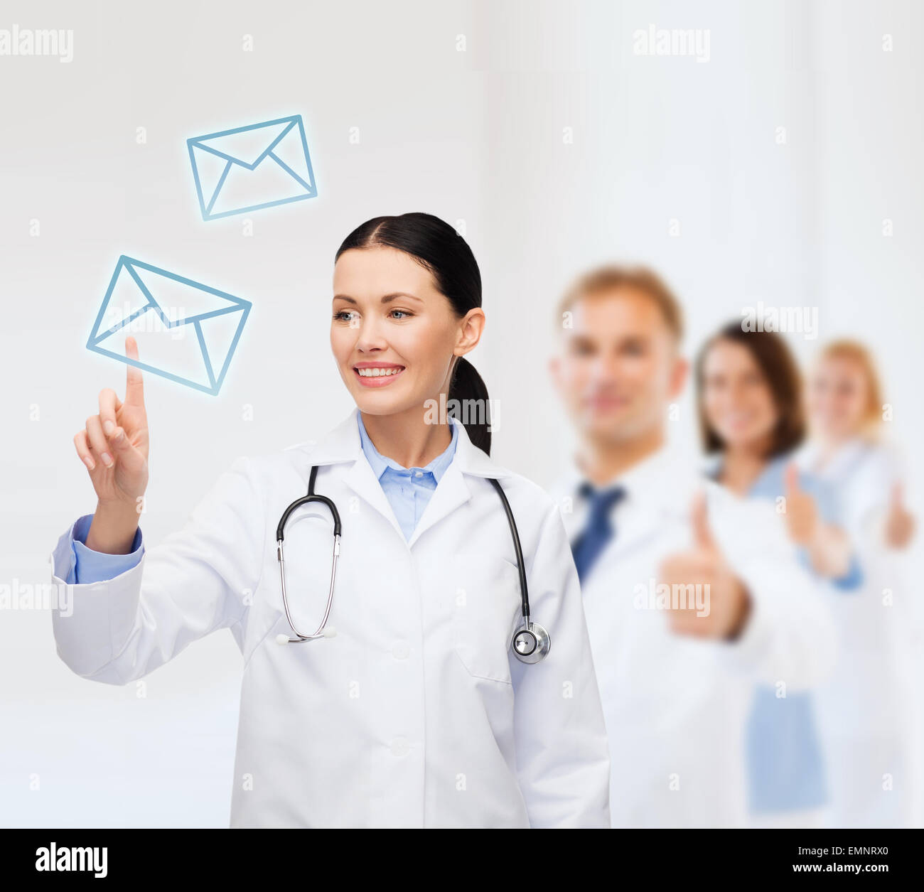smiling female doctor pointing to envelope Stock Photo - Alamy