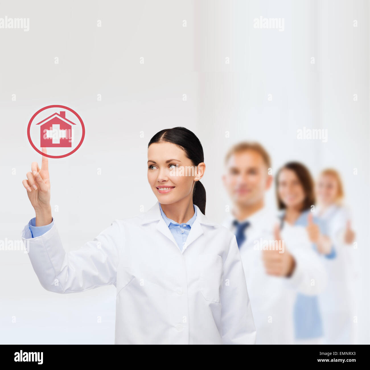 smiling female doctor pointing to hospital sign Stock Photo - Alamy