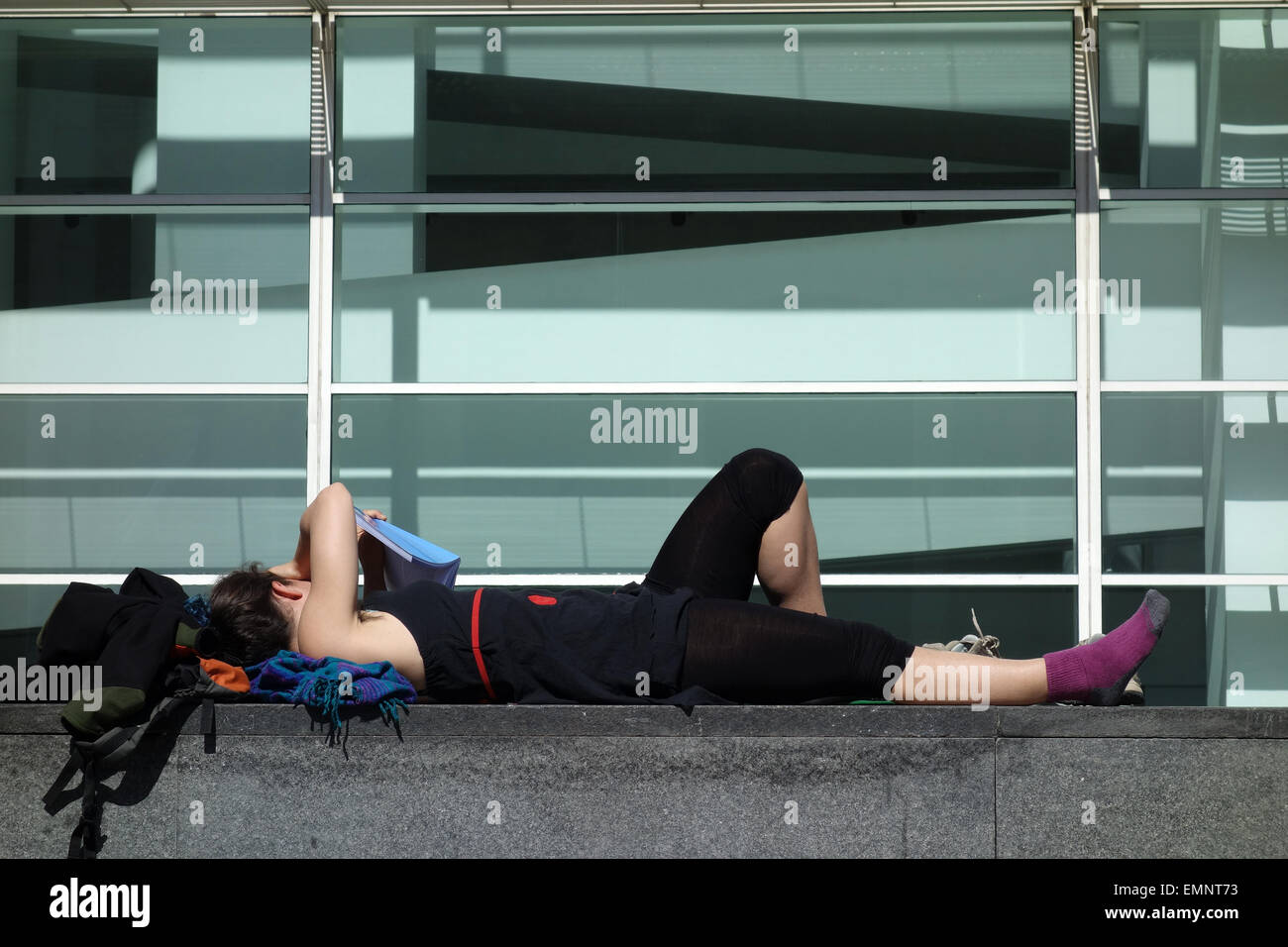 Young woman lying on wall hi-res stock photography and images - Alamy