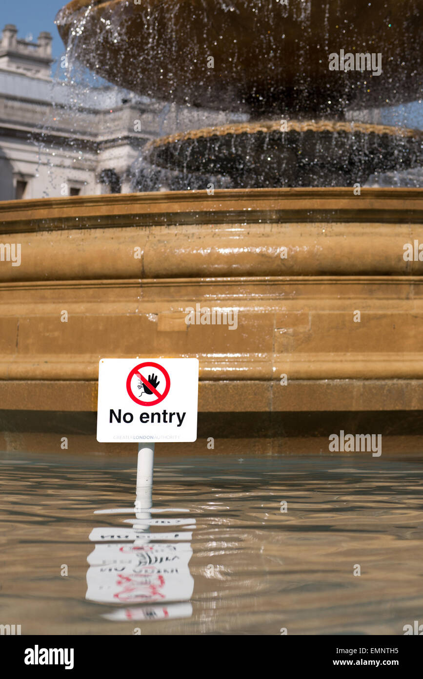 No entry sign in the water of one of the fountains at Trafalgar Square ...