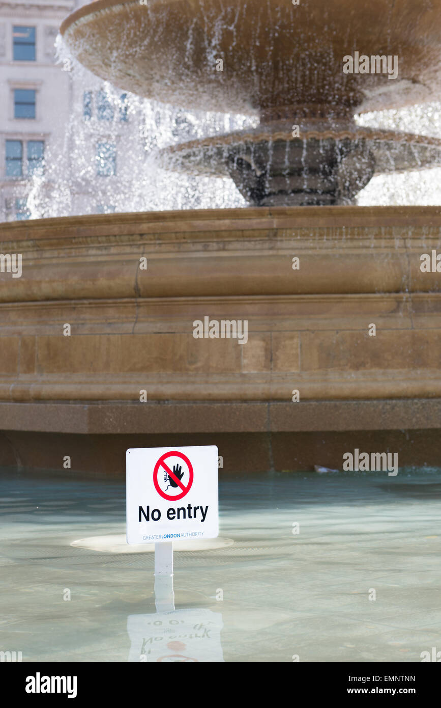 No entry sign in the water of one of the fountains at Trafalgar Square ...