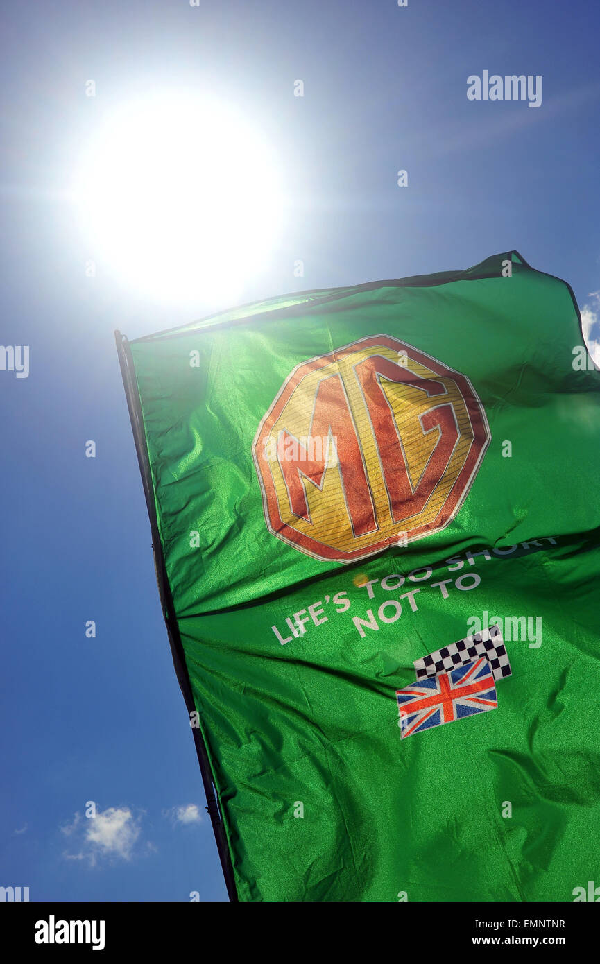 An MG cars banner with the glaring summer sun behind it a a car show ...